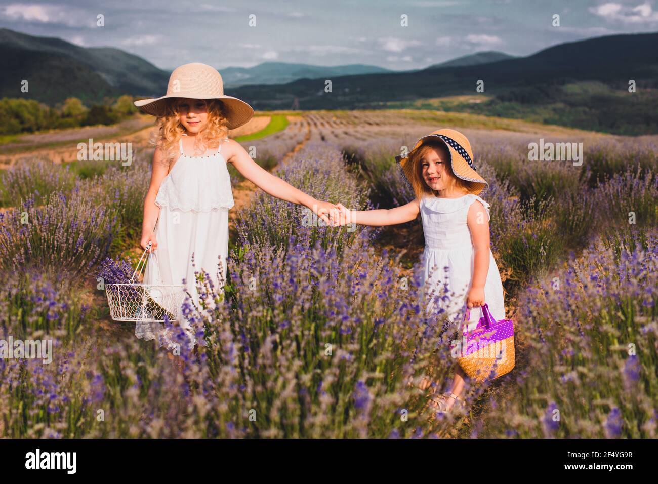 Two cute sisters travel through beautiful nature Stock Photo - Alamy