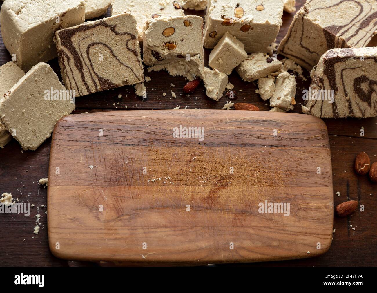 Halva variety cocoa and almonds on wooden table background, copy space ...
