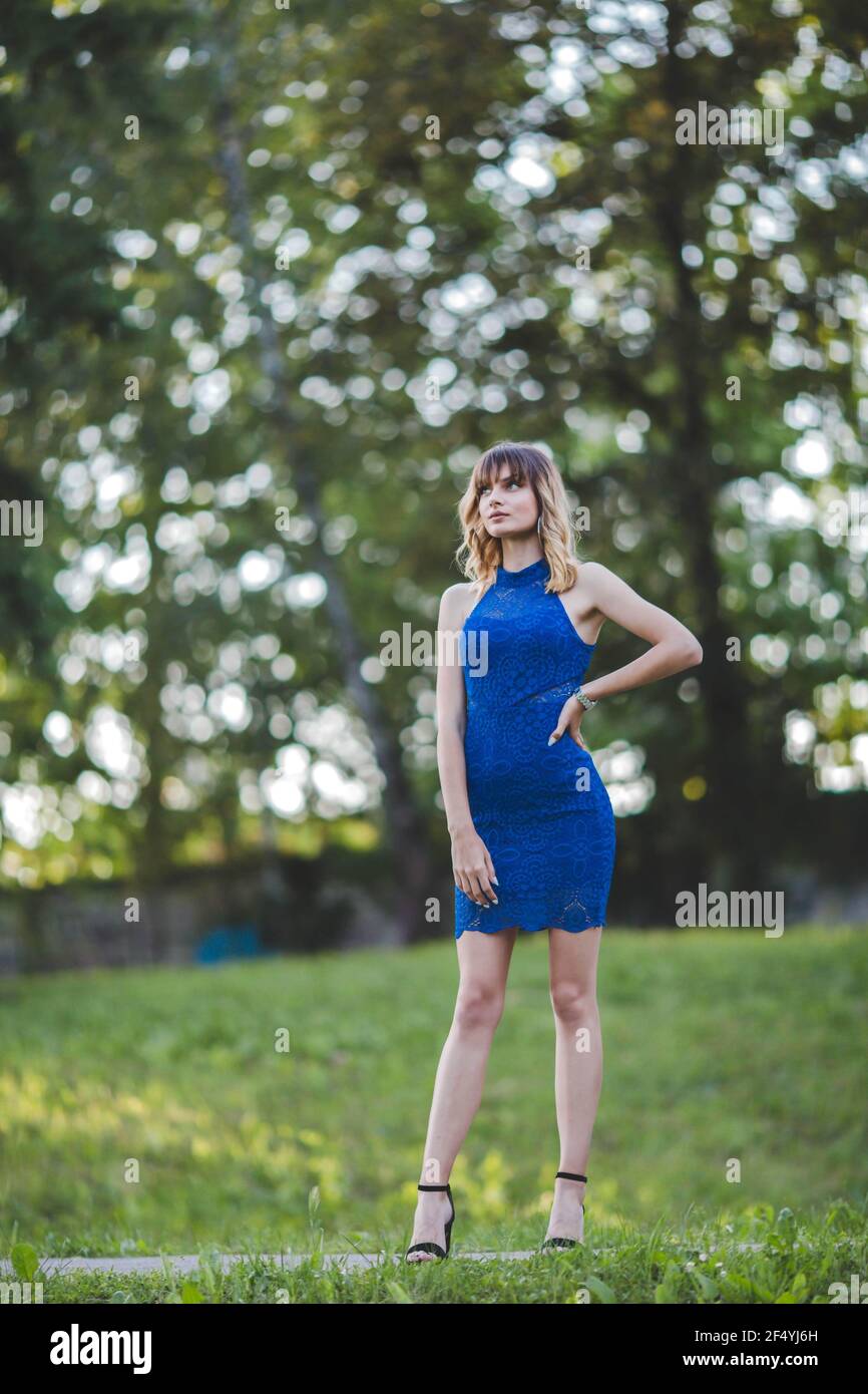 Vertical shot of a young Caucasian female posing in a sunny park Stock ...