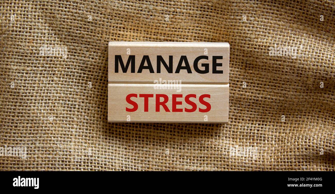 Manage stress and be health symbol. Wooden blocks with words 'manage ...