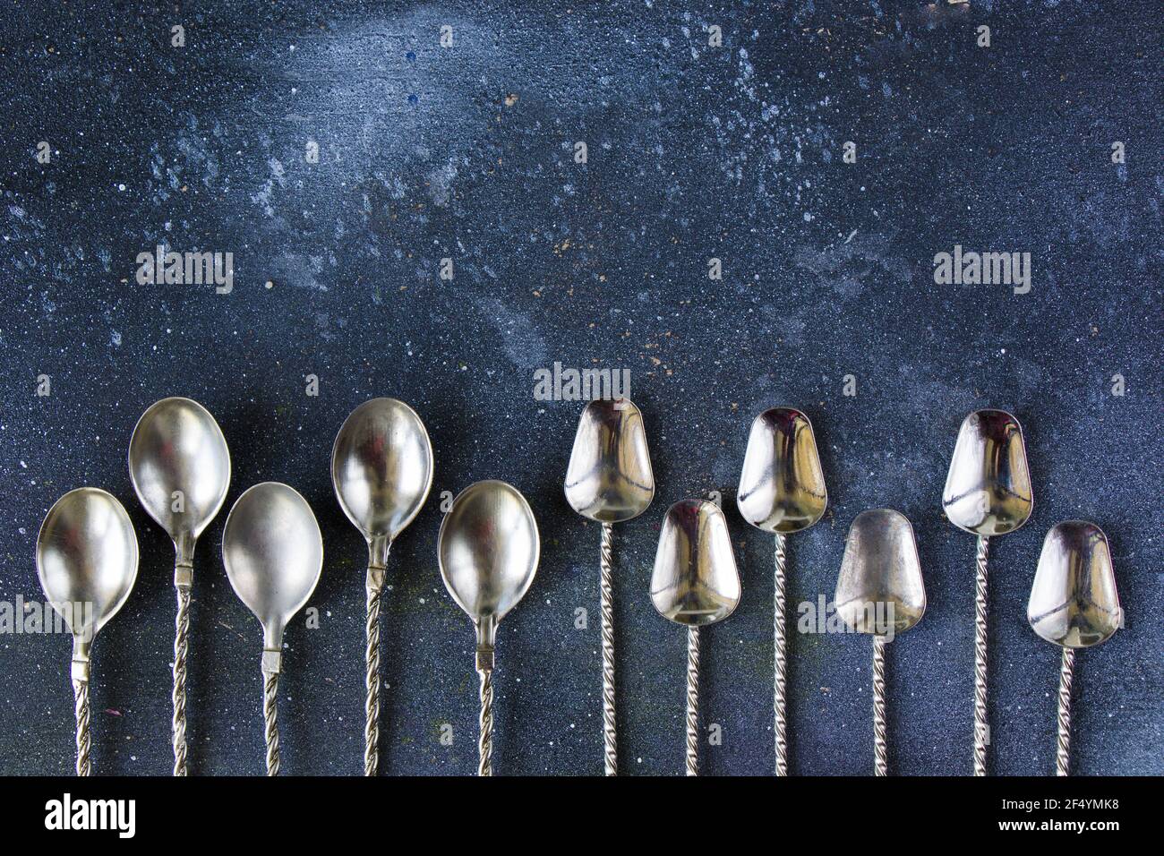 Vintage spoon set on blue background Stock Photo - Alamy