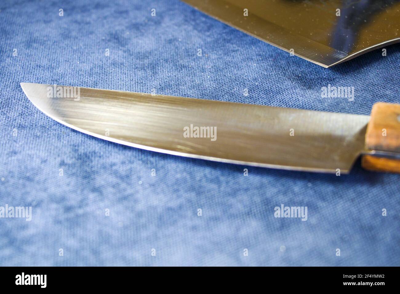 Sharp knife on blue background Stock Photo - Alamy