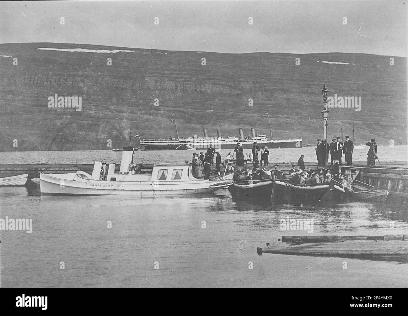 Akureyri (Iceland). Harbor basins with steam bar and boats when the ...