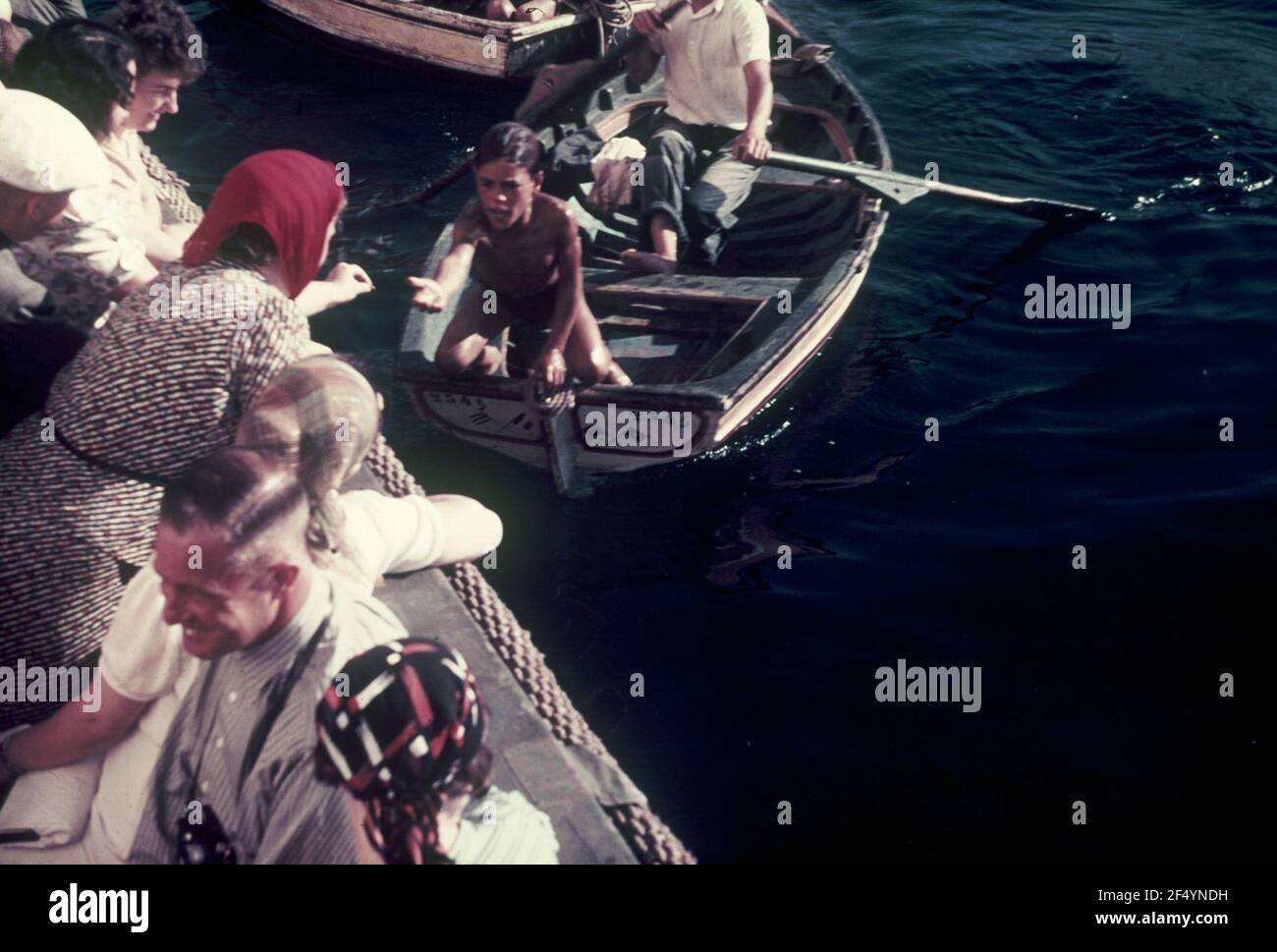 Travel photos. Ship passengers on the reeling, a native boy in a ...