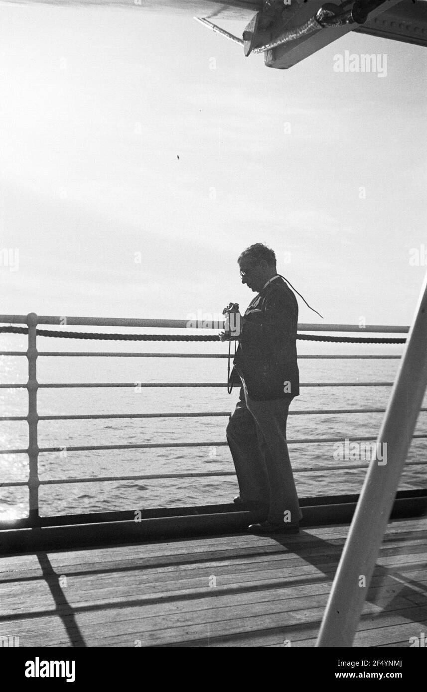 Travel photos. Man at the reeling of a passenger ship Stock Photo - Alamy