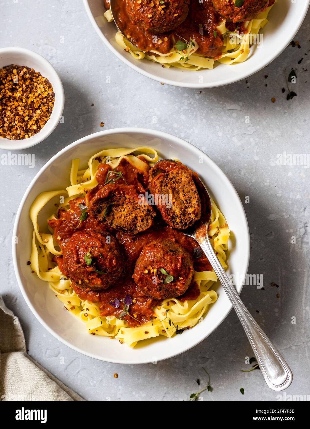Dinner scene - bowl of freshly made pasta with vegan tempeh and black ...