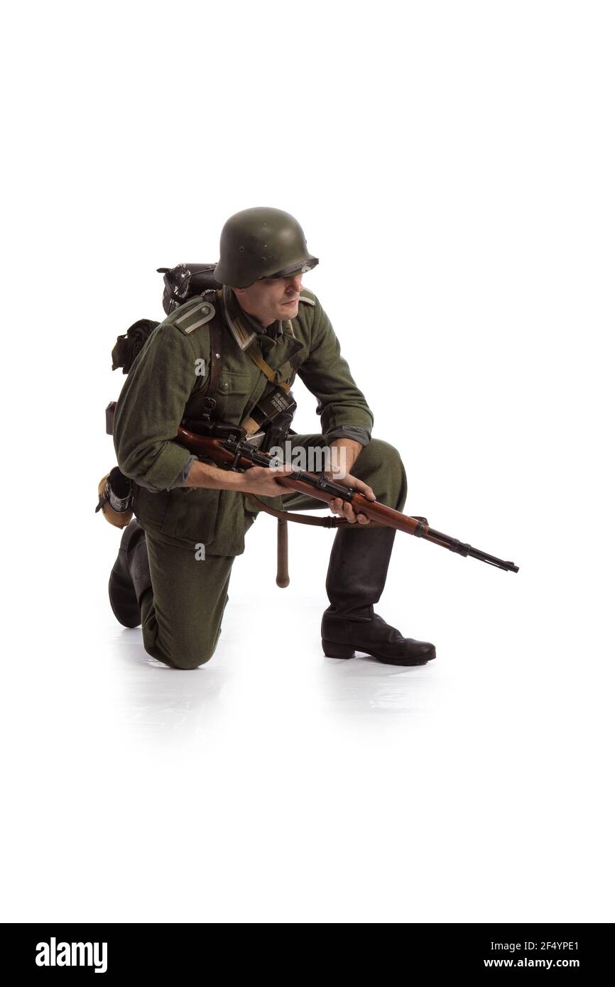 Man actor in the movie role of an military man with a machine gun ...