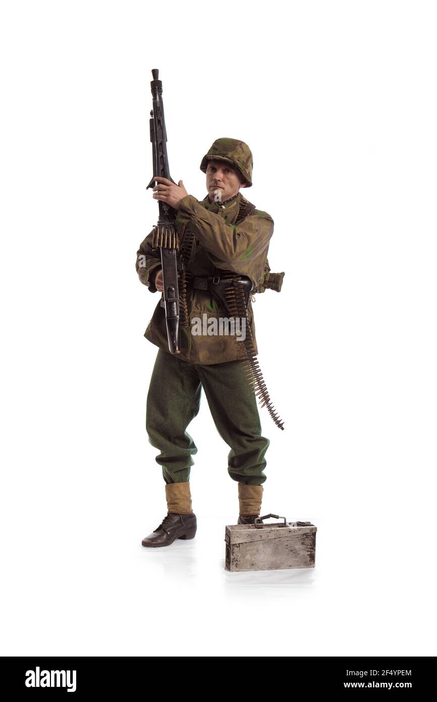 Man actor in the movie role of an military man with a machine gun ...