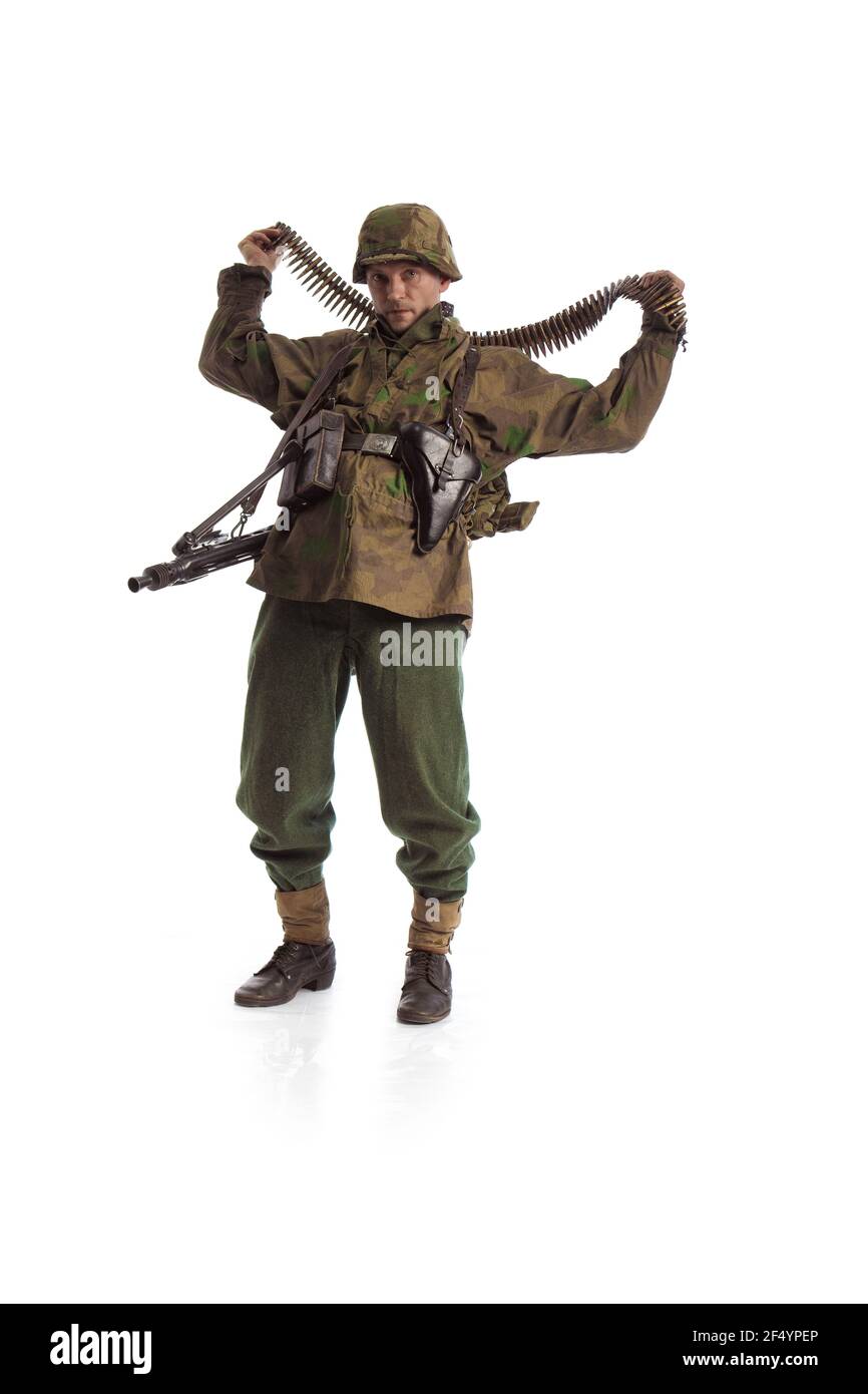 Man actor in the movie role of an military man with a machine gun ...