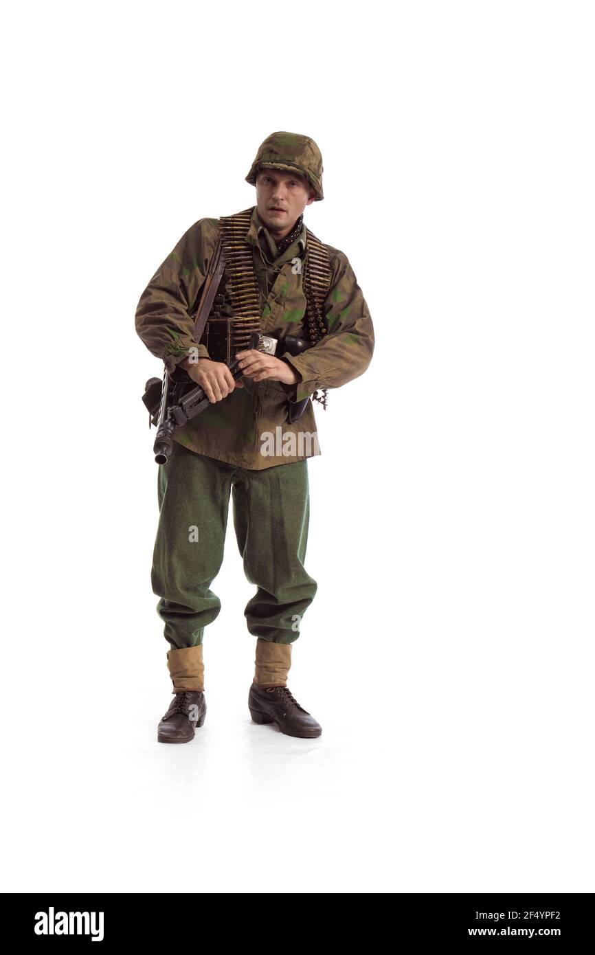 Man actor in the movie role of an military man with a machine gun ...