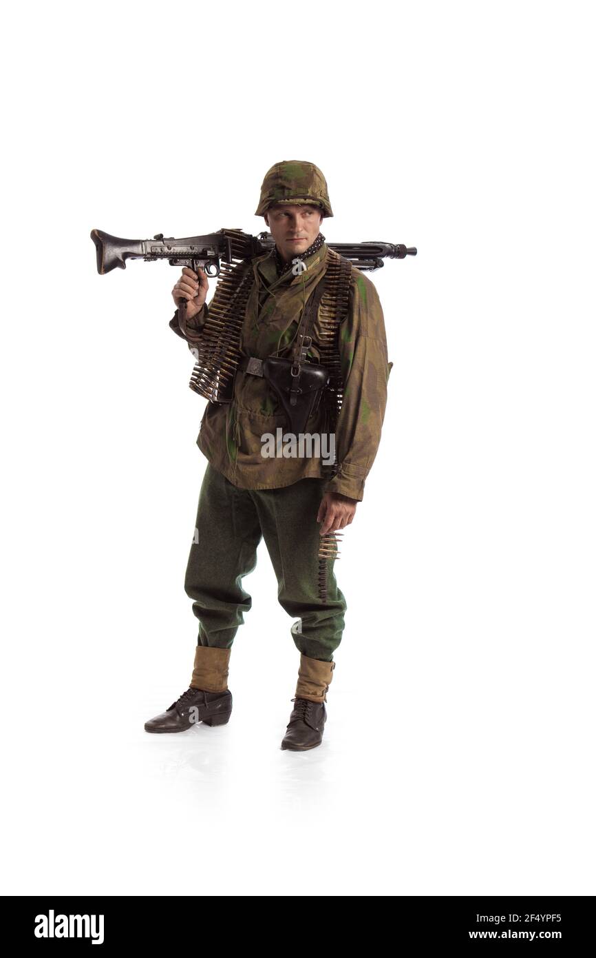 Man actor in the movie role of an military man with a machine gun ...