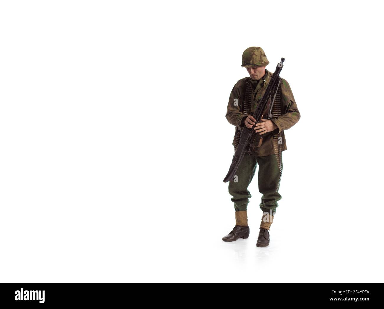 Man actor in the movie role of an military man with a machine gun ...