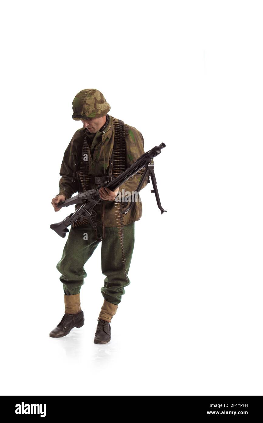 Man actor in the movie role of an military man with a machine gun ...