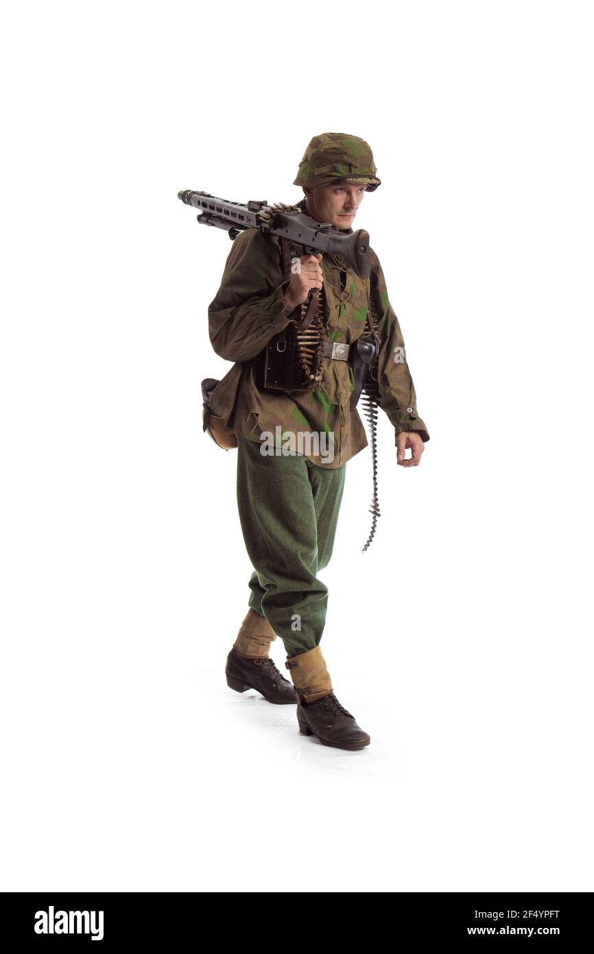 Man actor in the movie role of an military man with a machine gun ...