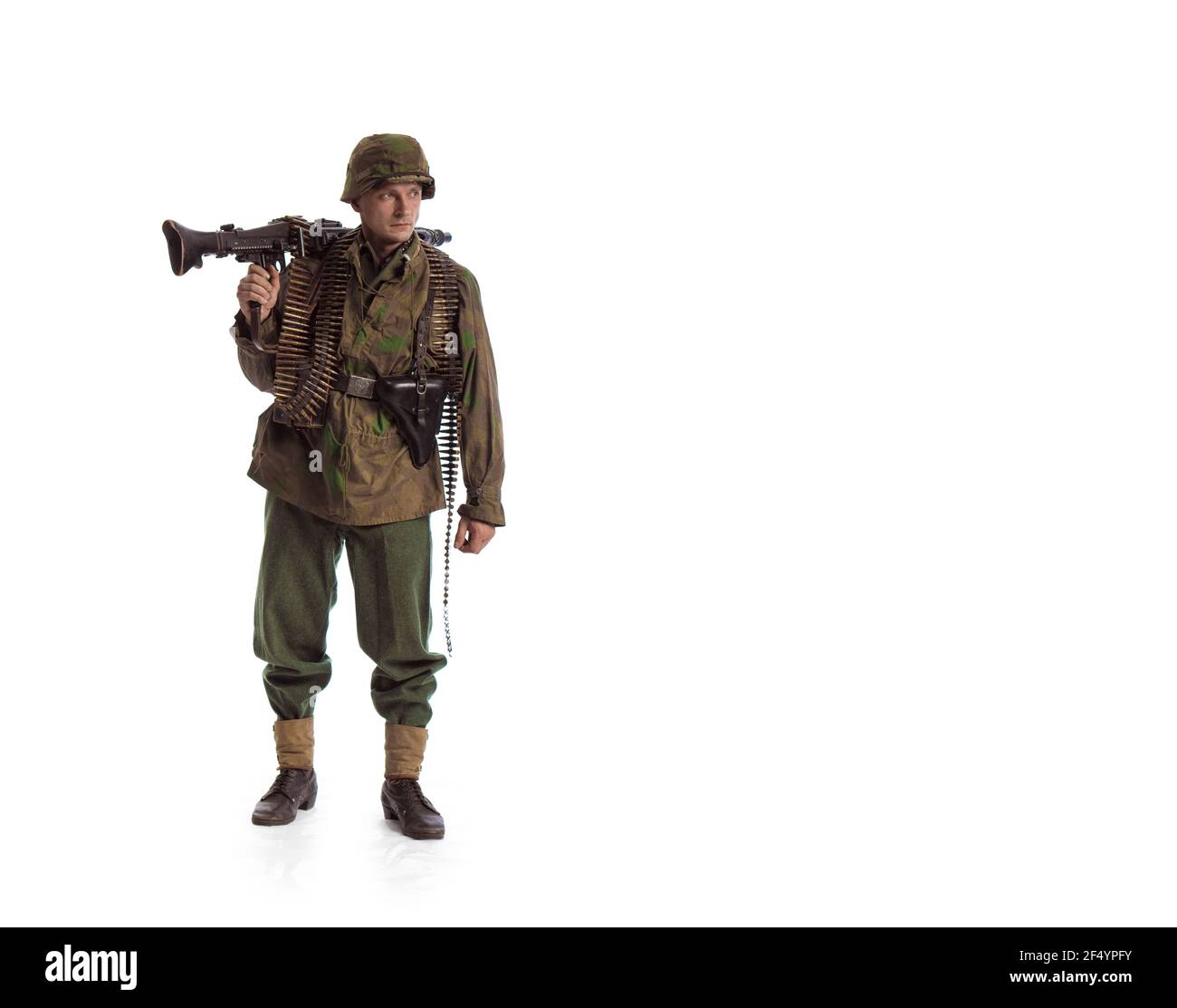 Man actor in the movie role of an military man with a machine gun ...