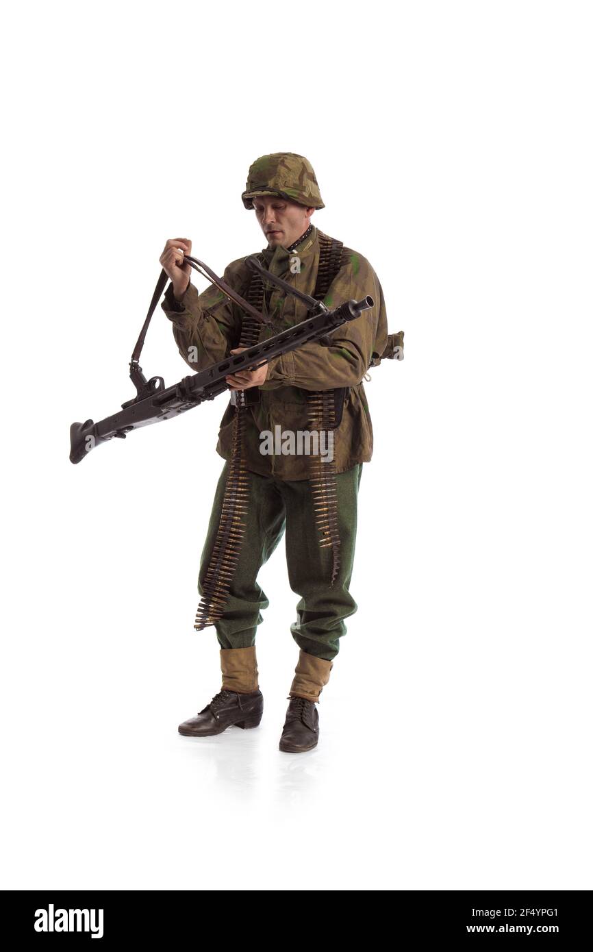Man actor in the movie role of an military man with a machine gun ...