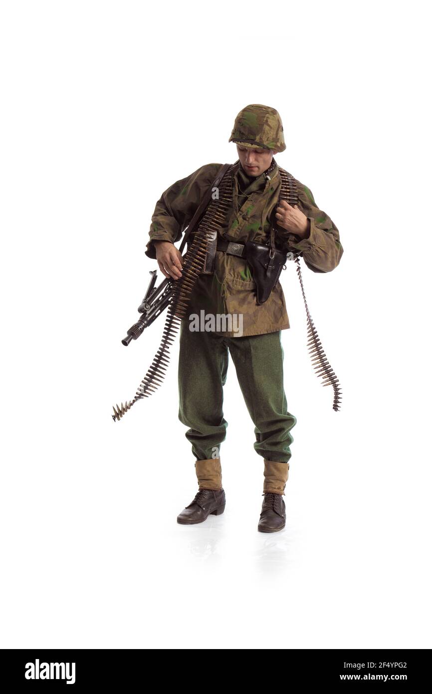 Man actor in the movie role of an military man with a machine gun ...