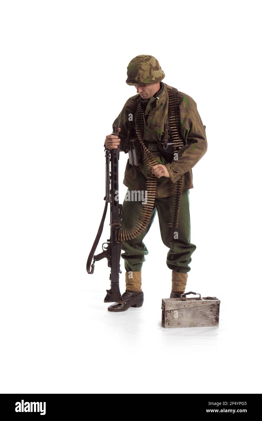 Man actor in the movie role of an military man with a machine gun ...