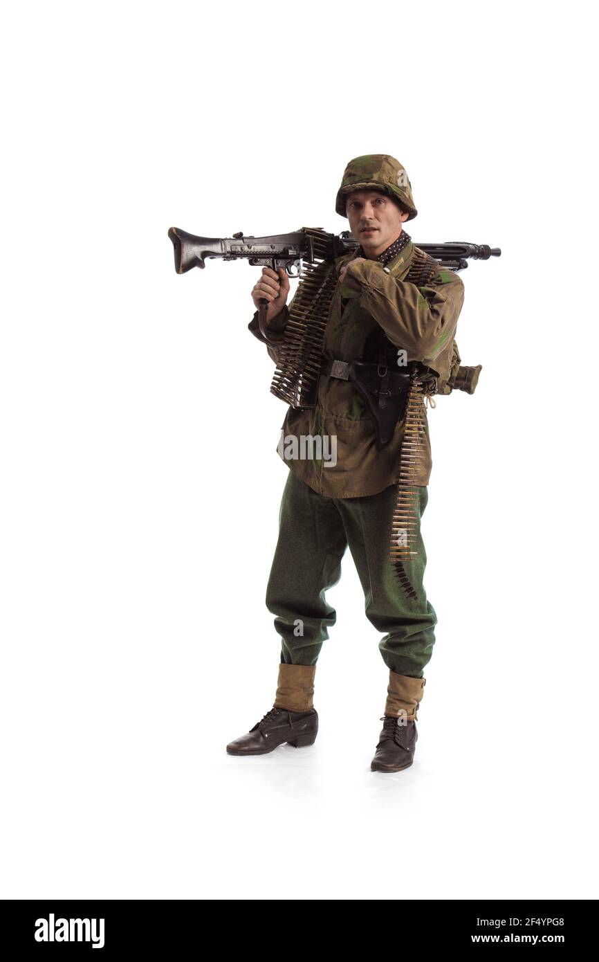 Man actor in the movie role of an military man with a machine gun ...