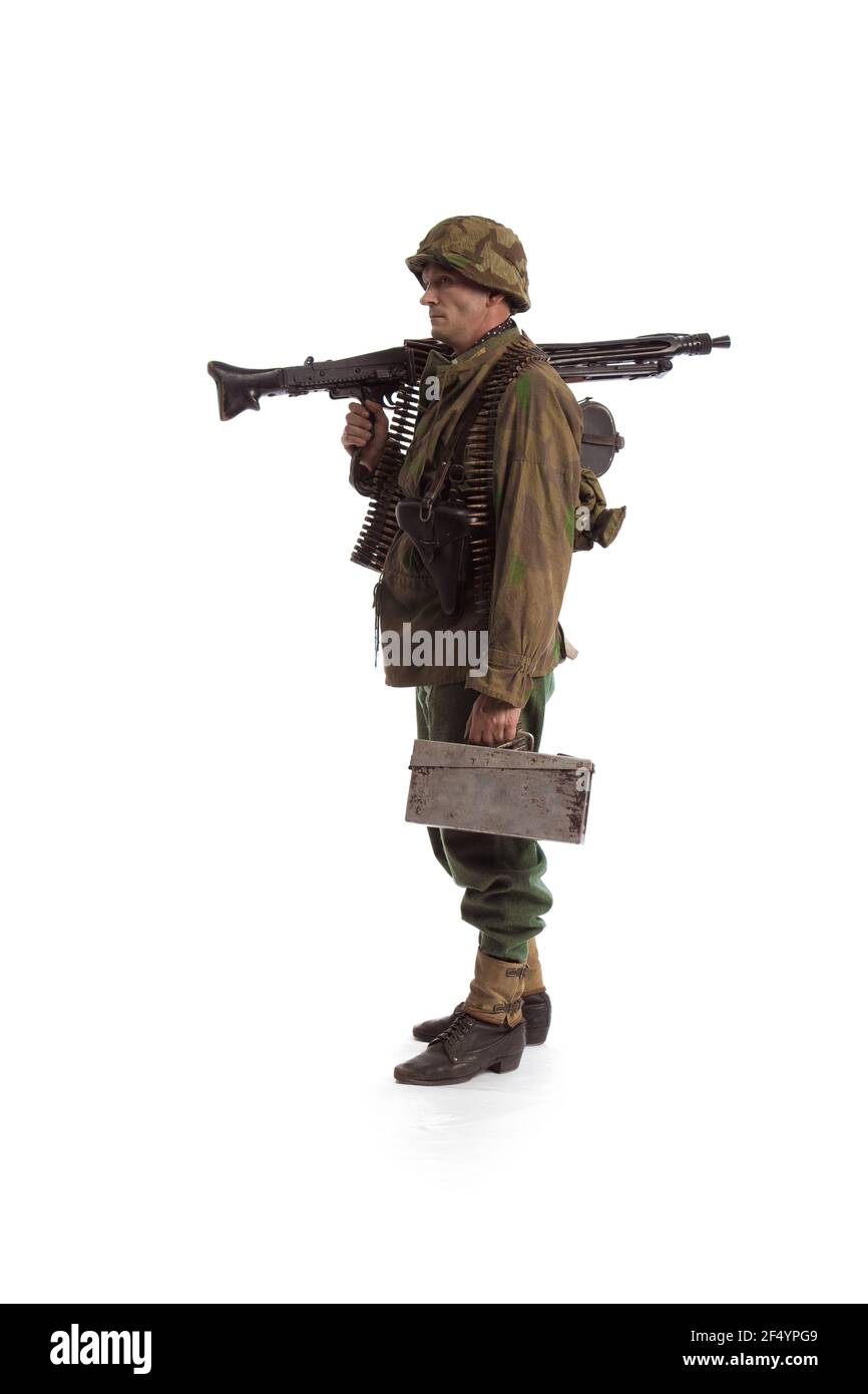 Man actor in the movie role of an military man with a machine gun ...