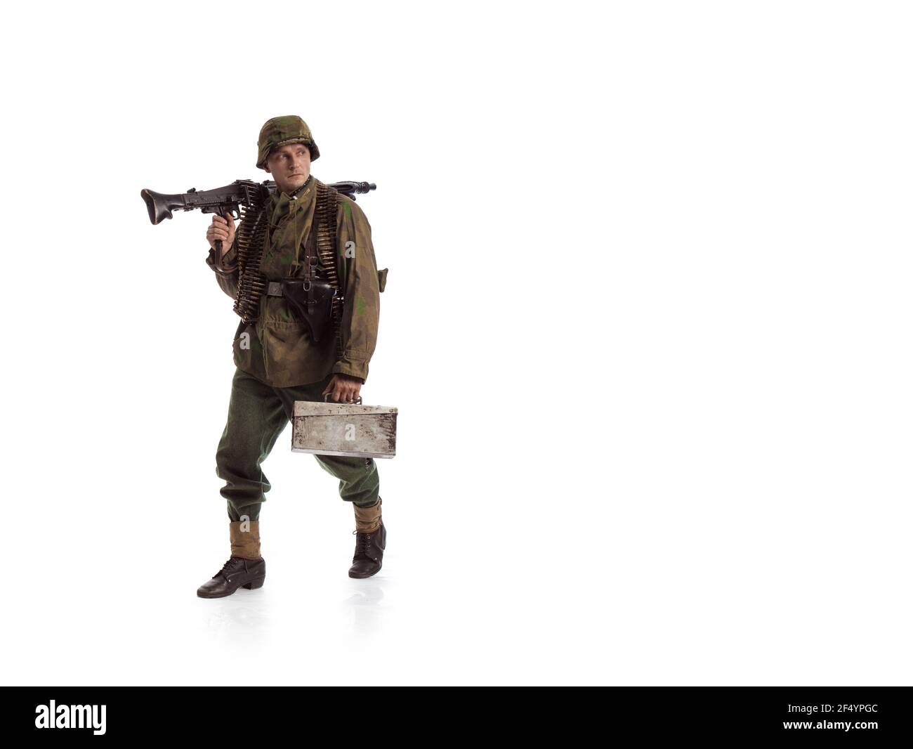 Man actor in the movie role of an military man with a machine gun ...