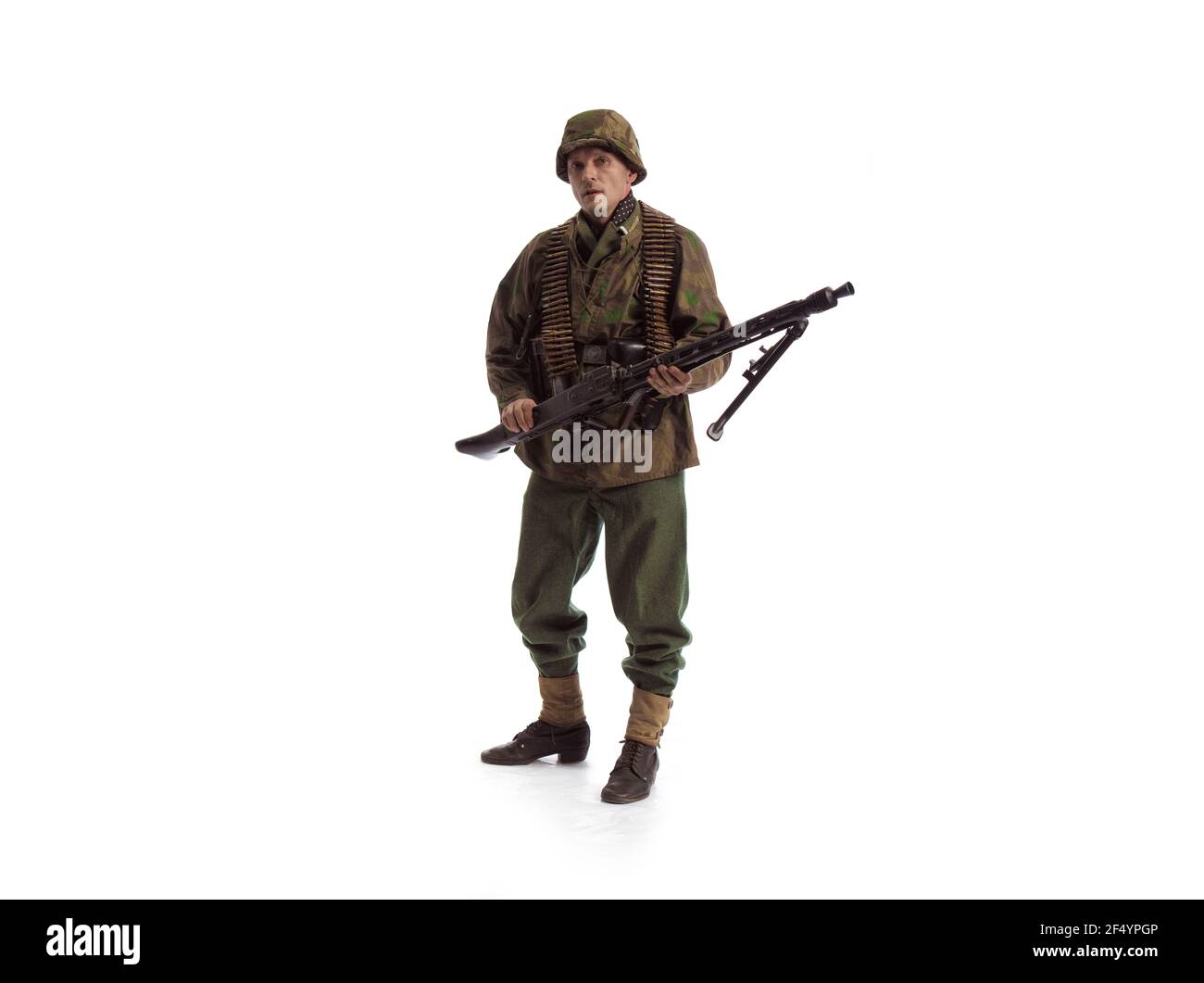 Man actor in the movie role of an military man with a machine gun ...