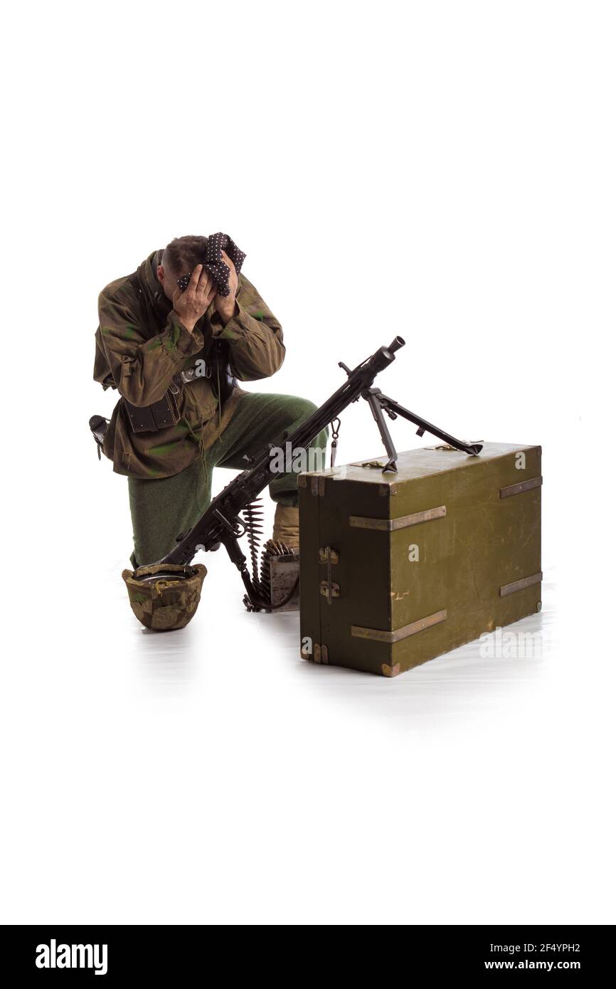 Man actor in the movie role of an military man with a machine gun ...