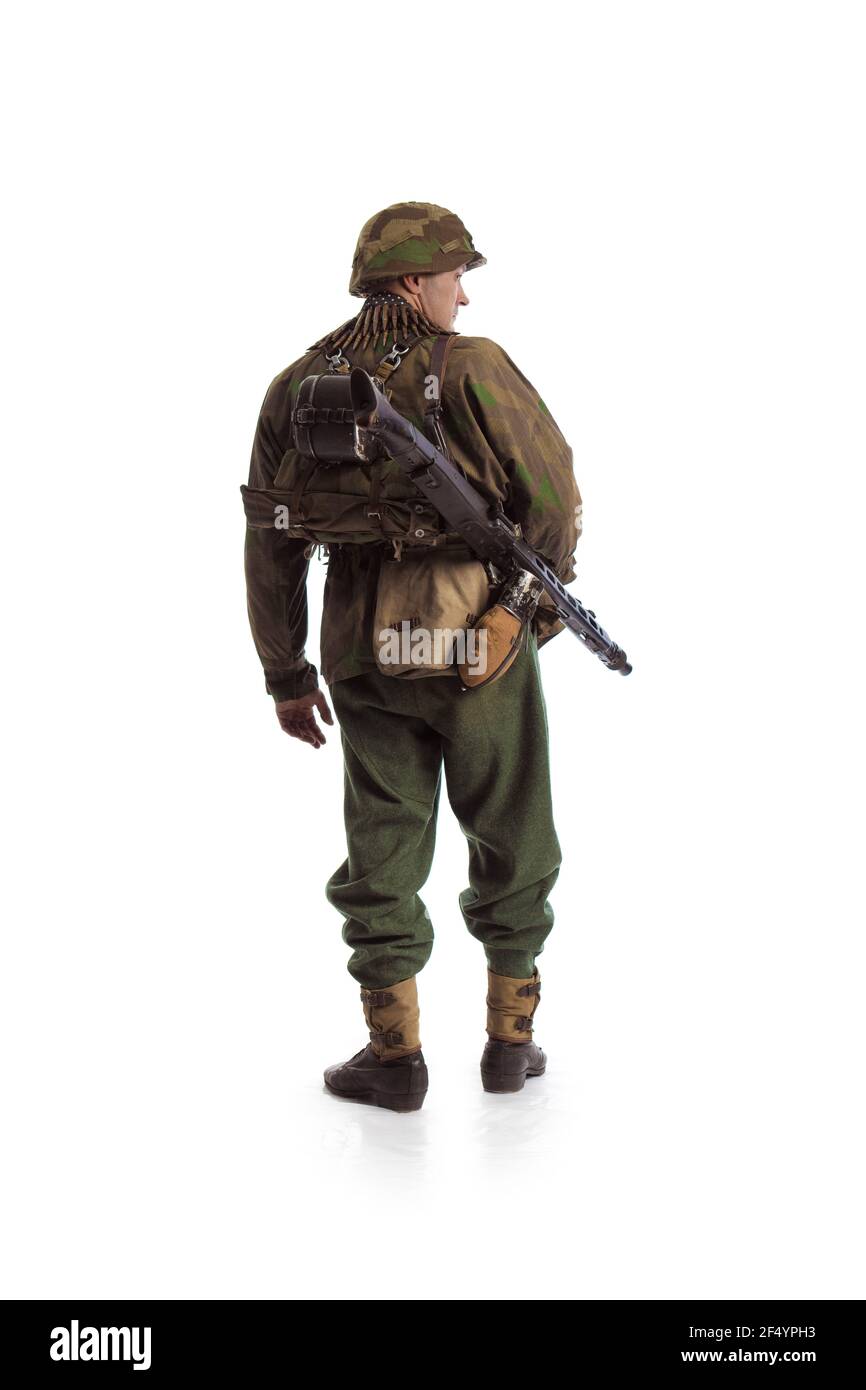 Man actor in the movie role of an military man with a machine gun ...