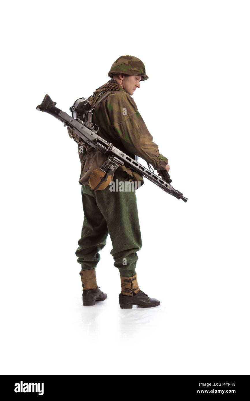 Man actor in the movie role of an military man with a machine gun ...