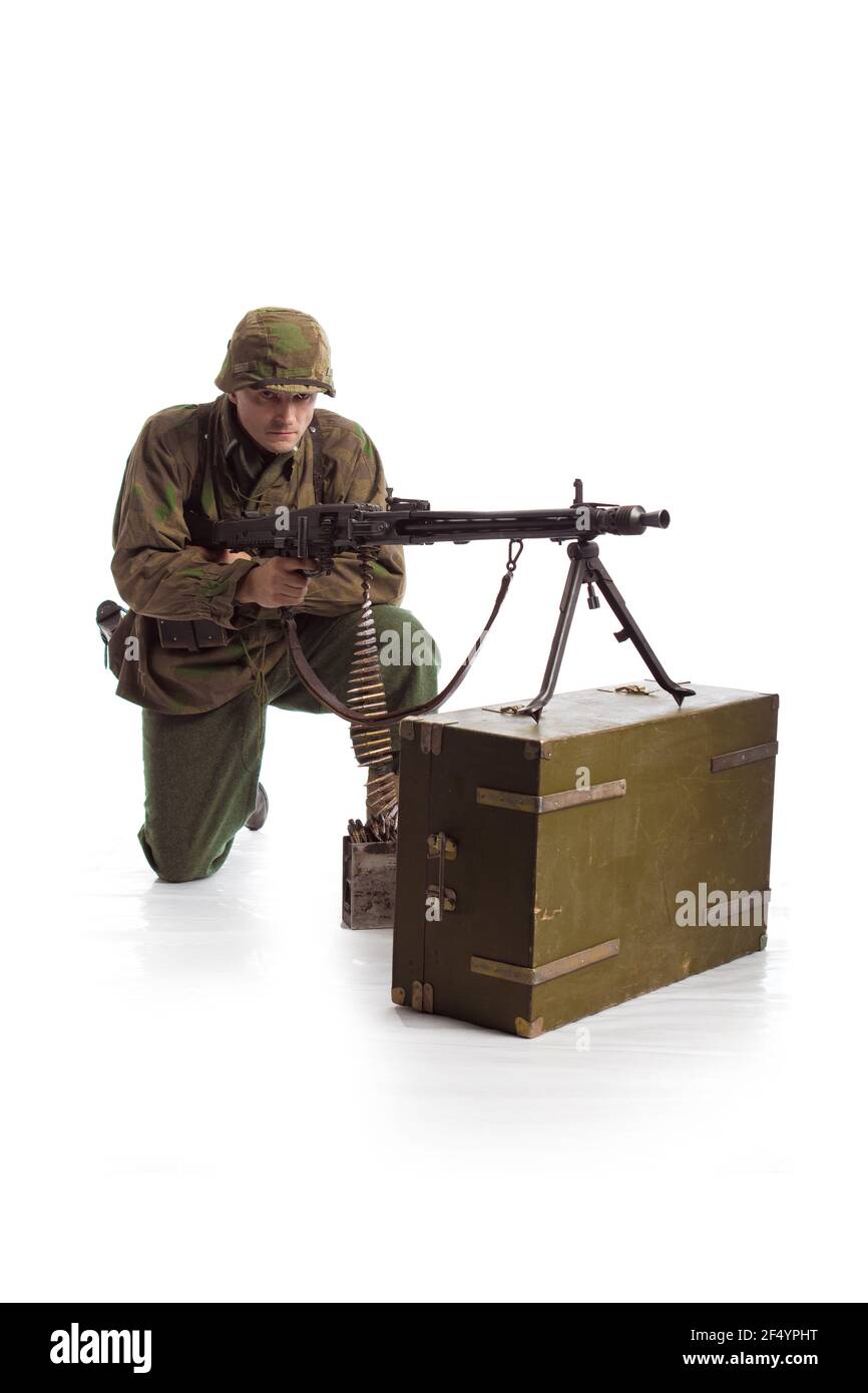 Man actor in the movie role of an military man with a machine gun ...