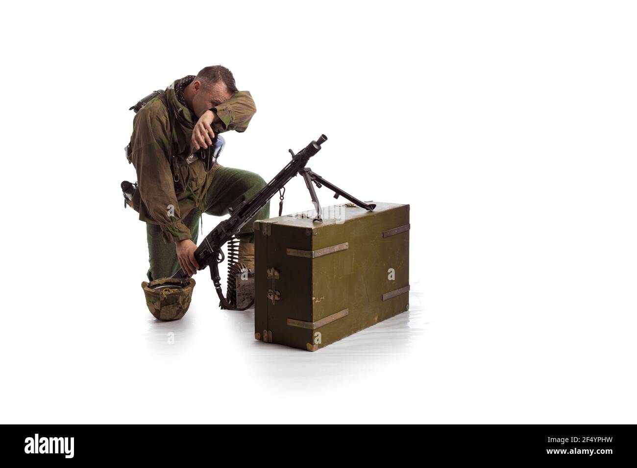 Man actor in the movie role of an military man with a machine gun ...