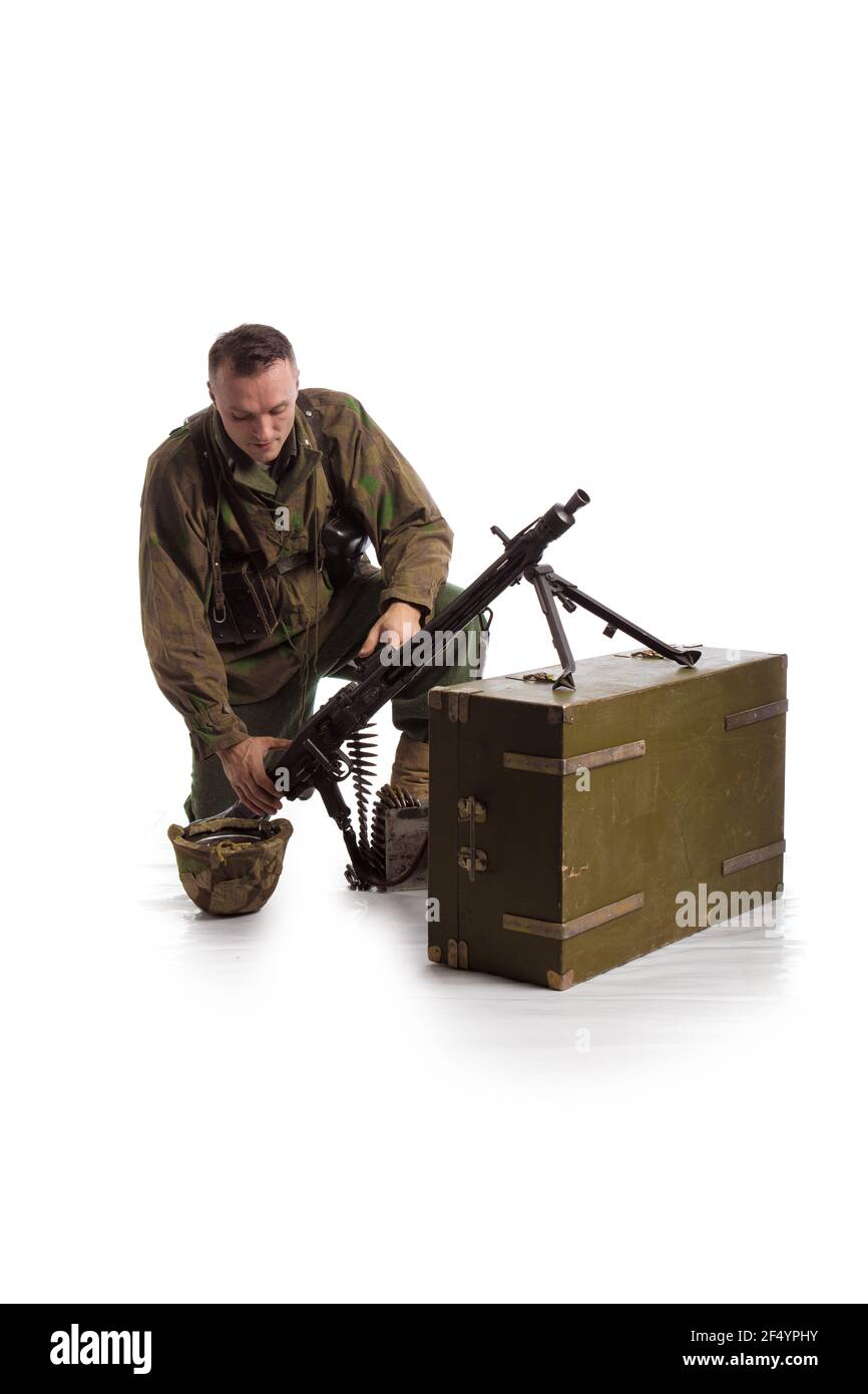 Man actor in the movie role of an military man with a machine gun ...