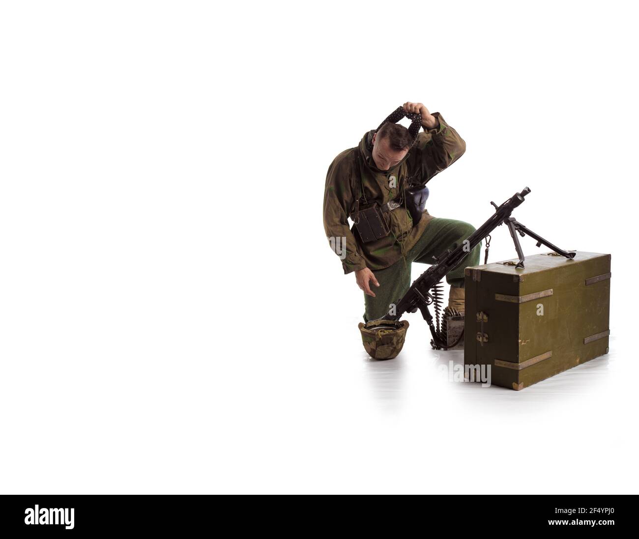 Man actor in the movie role of an military man with a machine gun ...