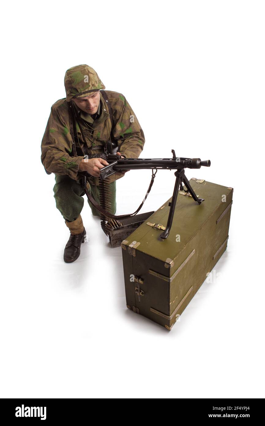 Man actor in the movie role of an military man with a machine gun ...