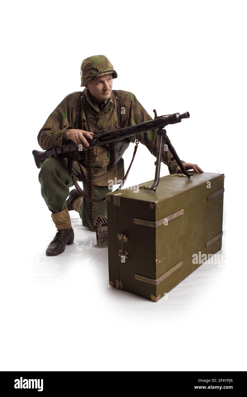 Man actor in the movie role of an military man with a machine gun ...