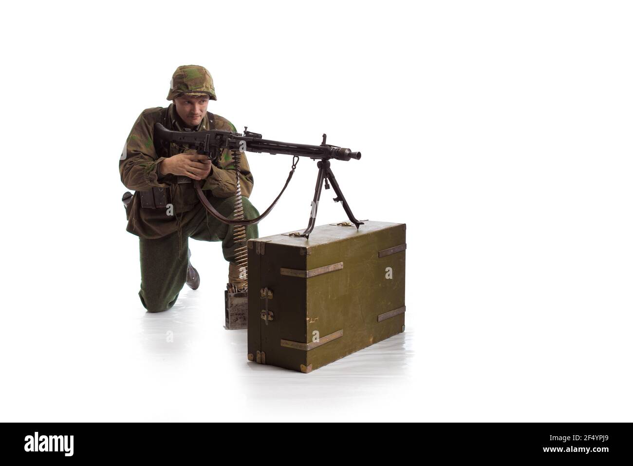 Man actor in the movie role of an military man with a machine gun ...