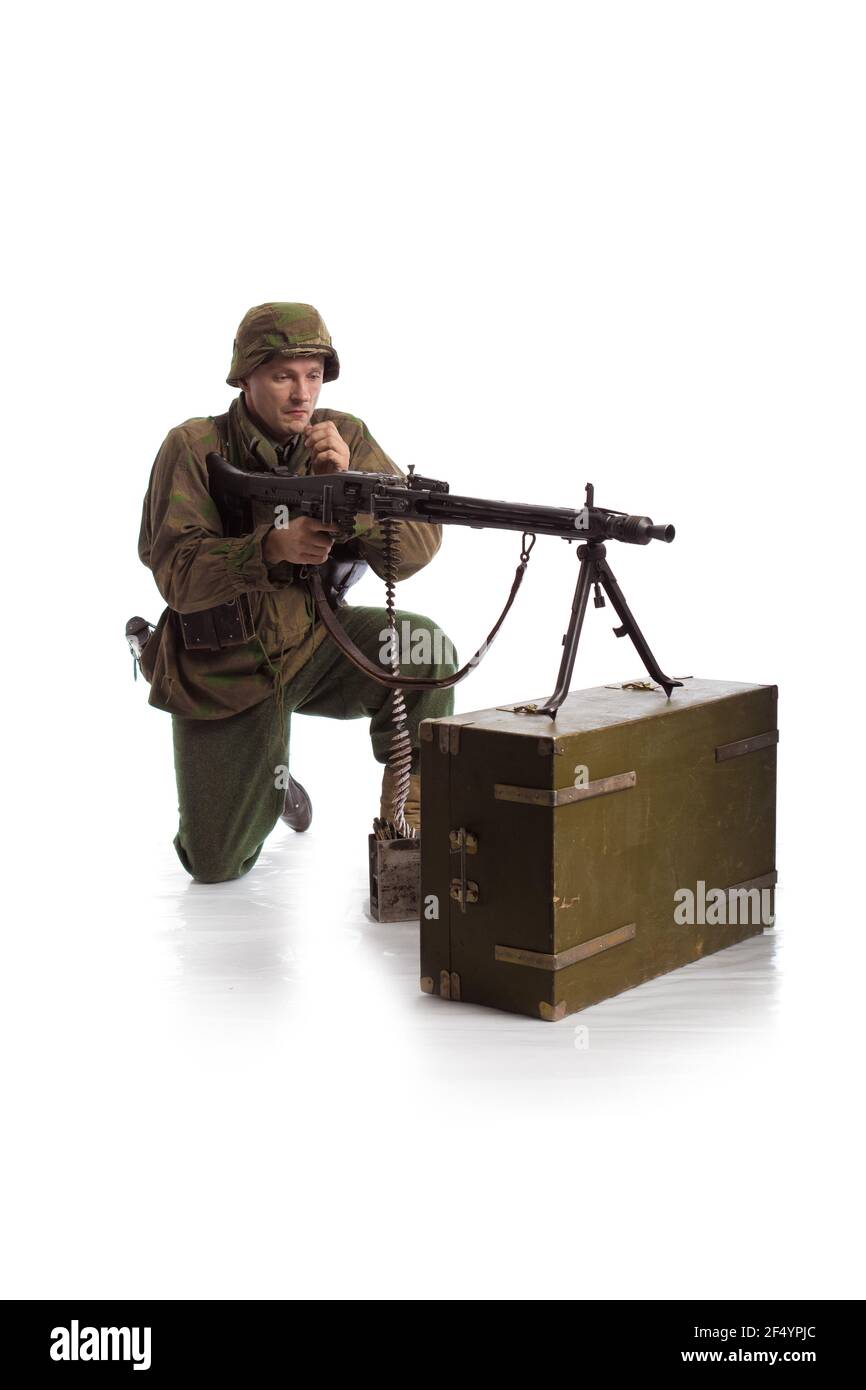 Man actor in the movie role of an military man with a machine gun ...