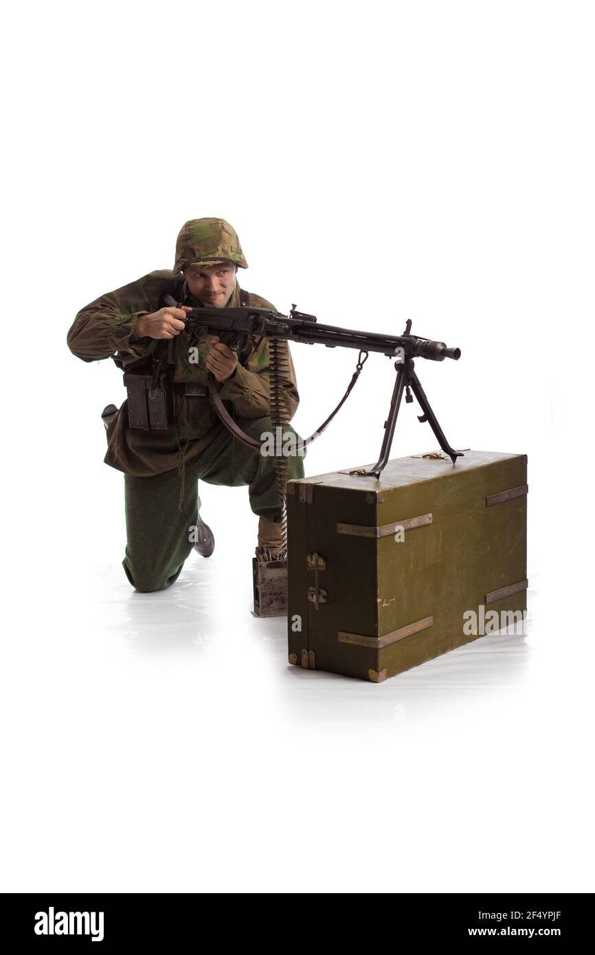 Man actor in the movie role of an military man with a machine gun ...