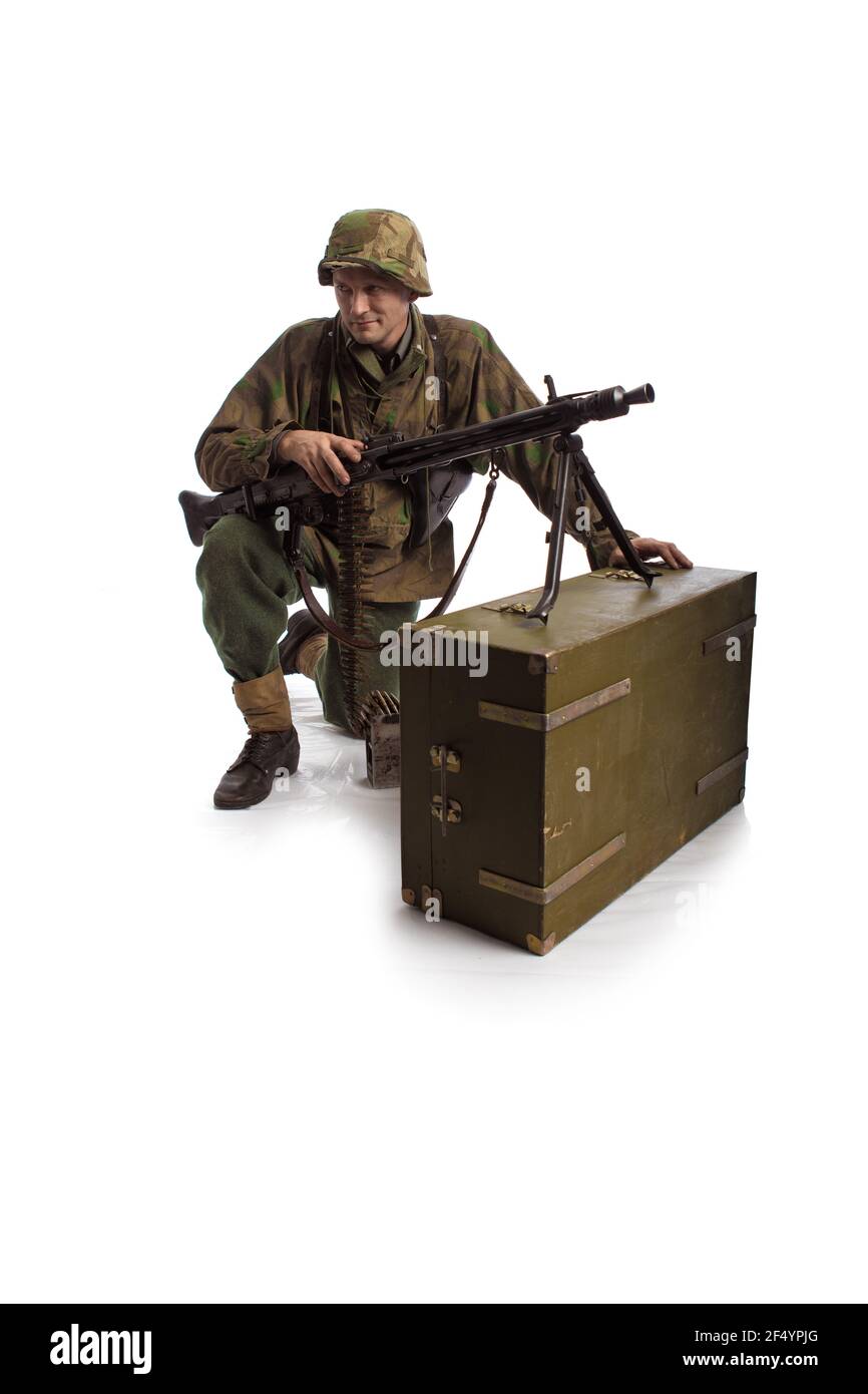 Man actor in the movie role of an military man with a machine gun ...