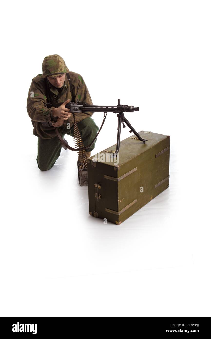 Man actor in the movie role of an military man with a machine gun ...