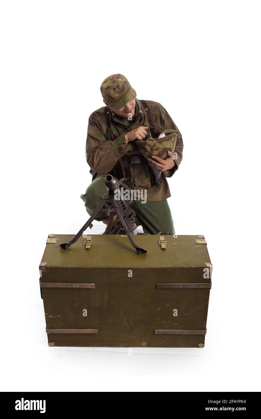 Man actor in the movie role of an military man with a machine gun ...