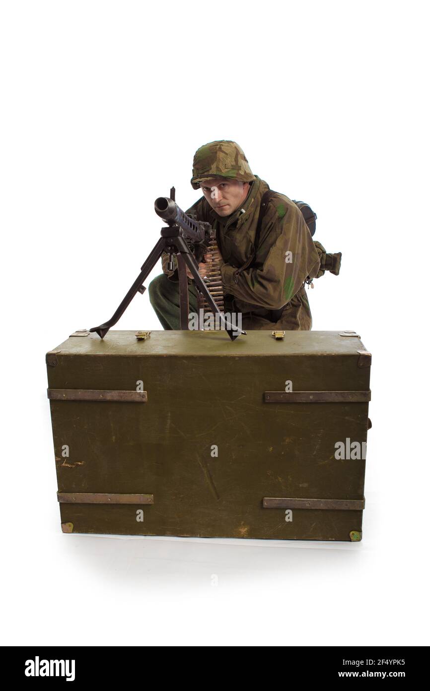 Man actor in the movie role of an military man with a machine gun ...