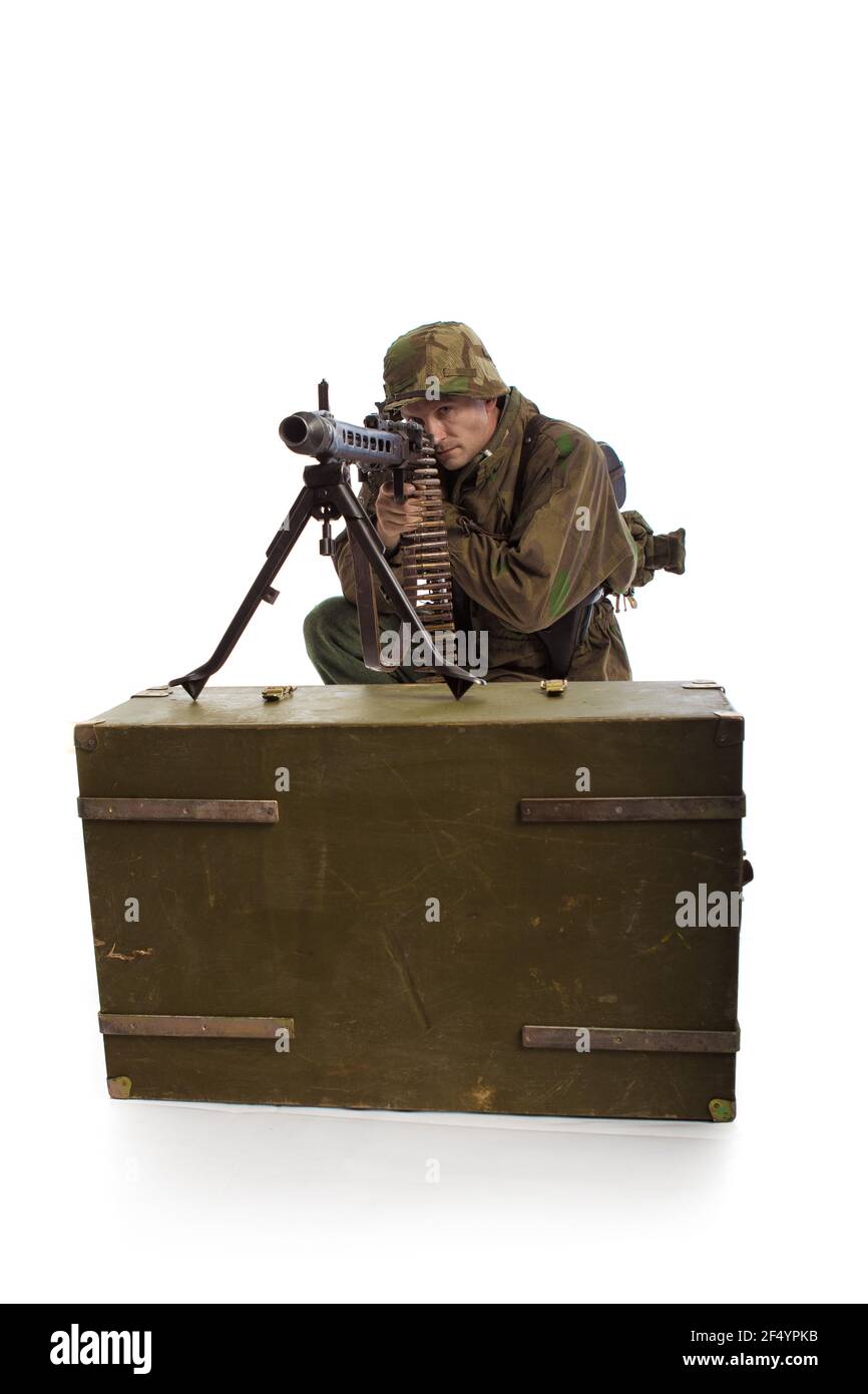 Man actor in the movie role of an military man with a machine gun ...