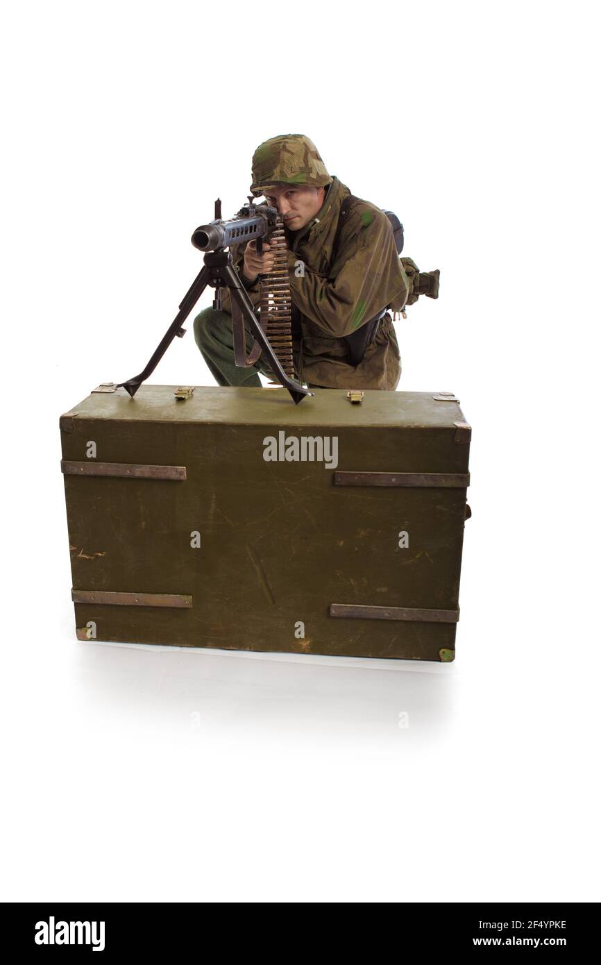 Man actor in the movie role of an military man with a machine gun ...