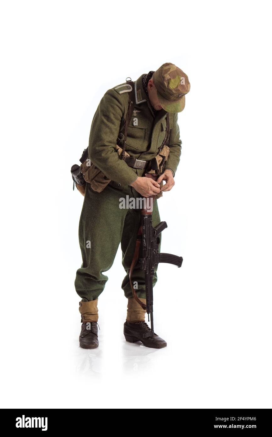 Man actor in the movie role of an military man with a machine gun ...