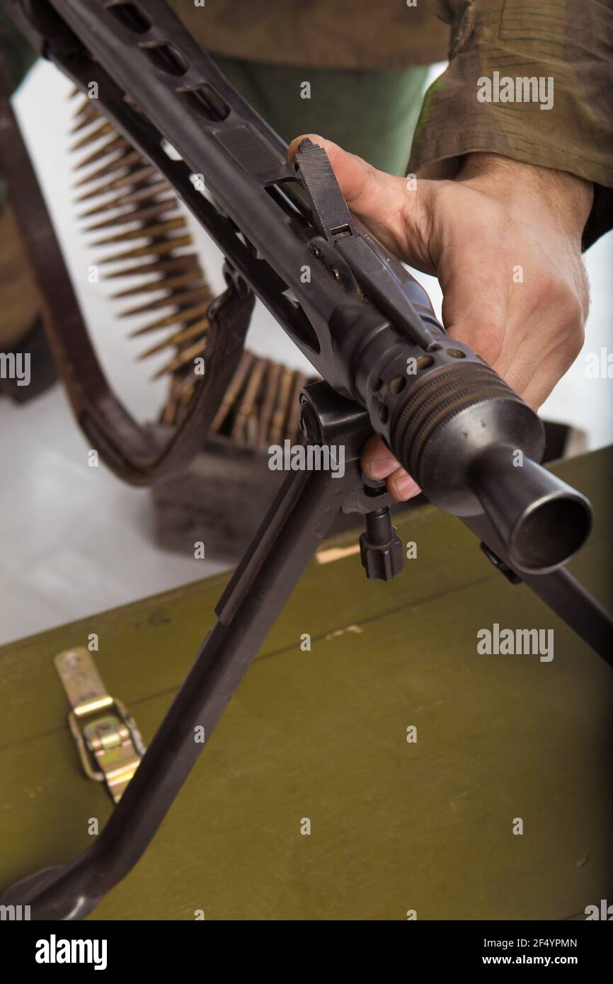 Man actor in the movie role of an military man with a machine gun ...