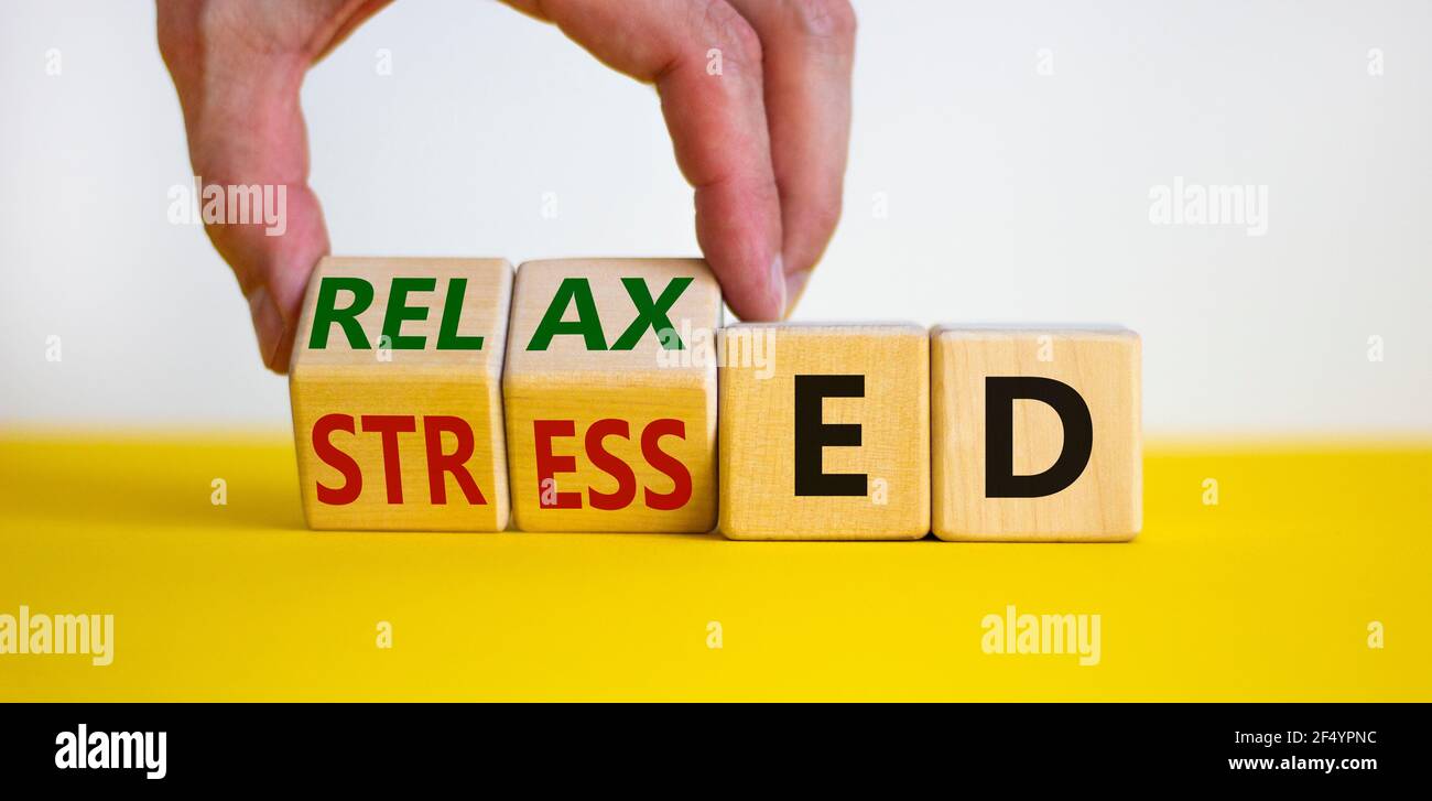 Stressed or relaxed symbol. Businessman turns cubes and changes the ...