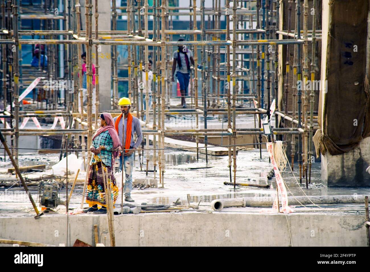 construction site in india at dusk with workers, people, labor ...