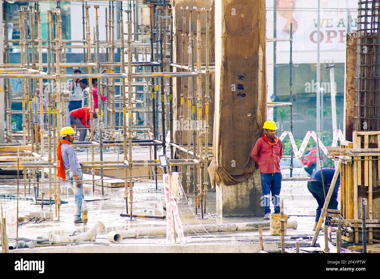 construction site in india at dusk with workers, people, labor ...