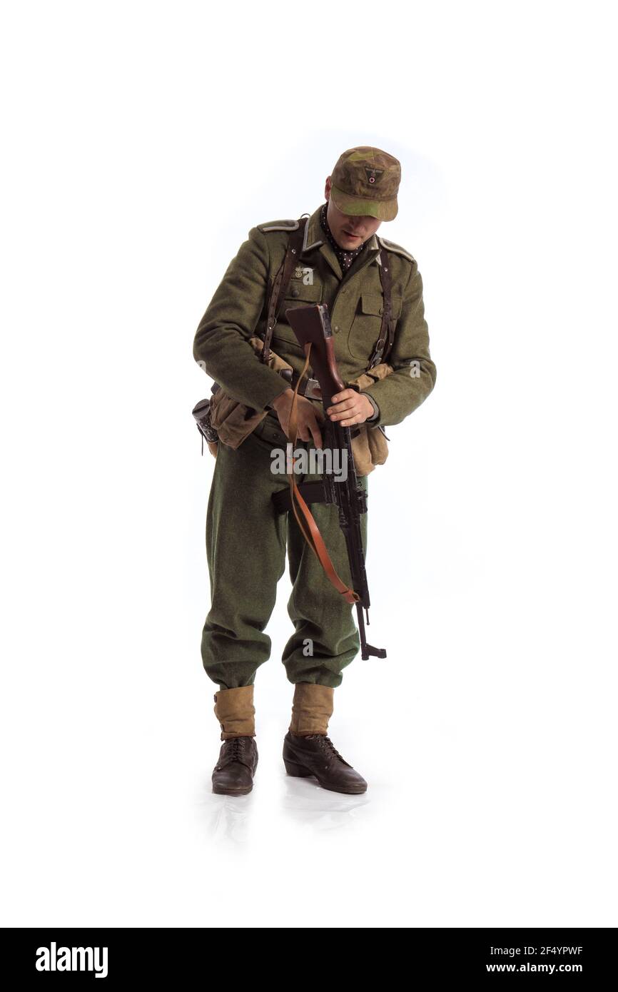 Man actor in the movie role of an military man with a machine gun ...